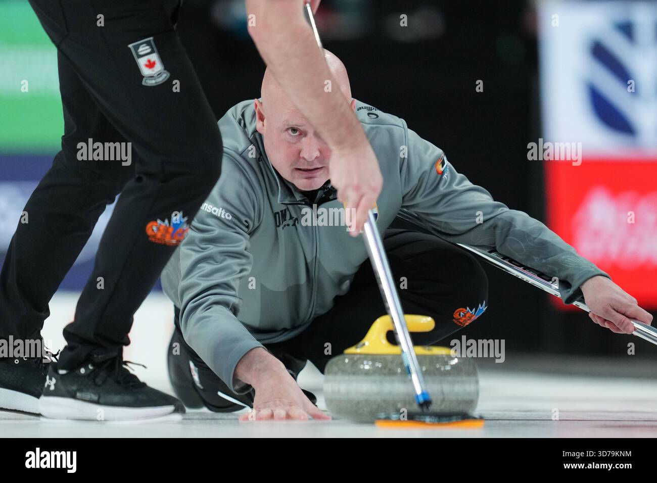 Kevin Koe throws a rock against Team McDonald during Canadian Olympic ...