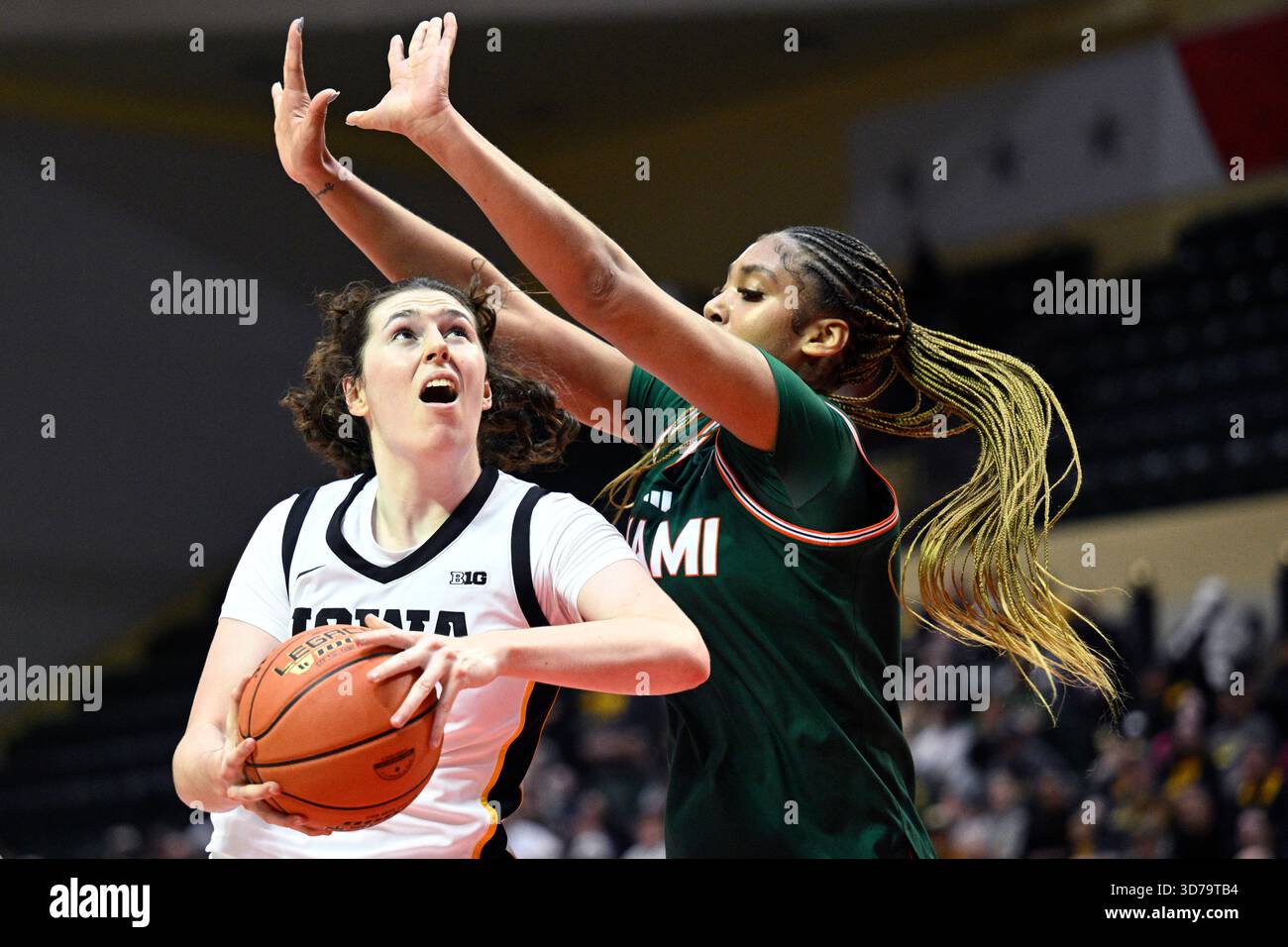 Iowa center Ava Heiden (5) goes up to shoot while defended by Miami ...