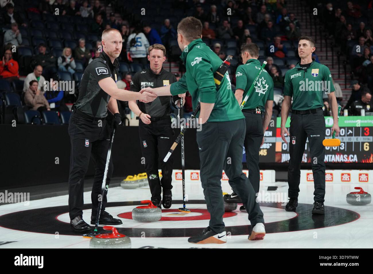 Brad Jacobs, left, shakes hands with Mike McEwen after Team Jacobs ...