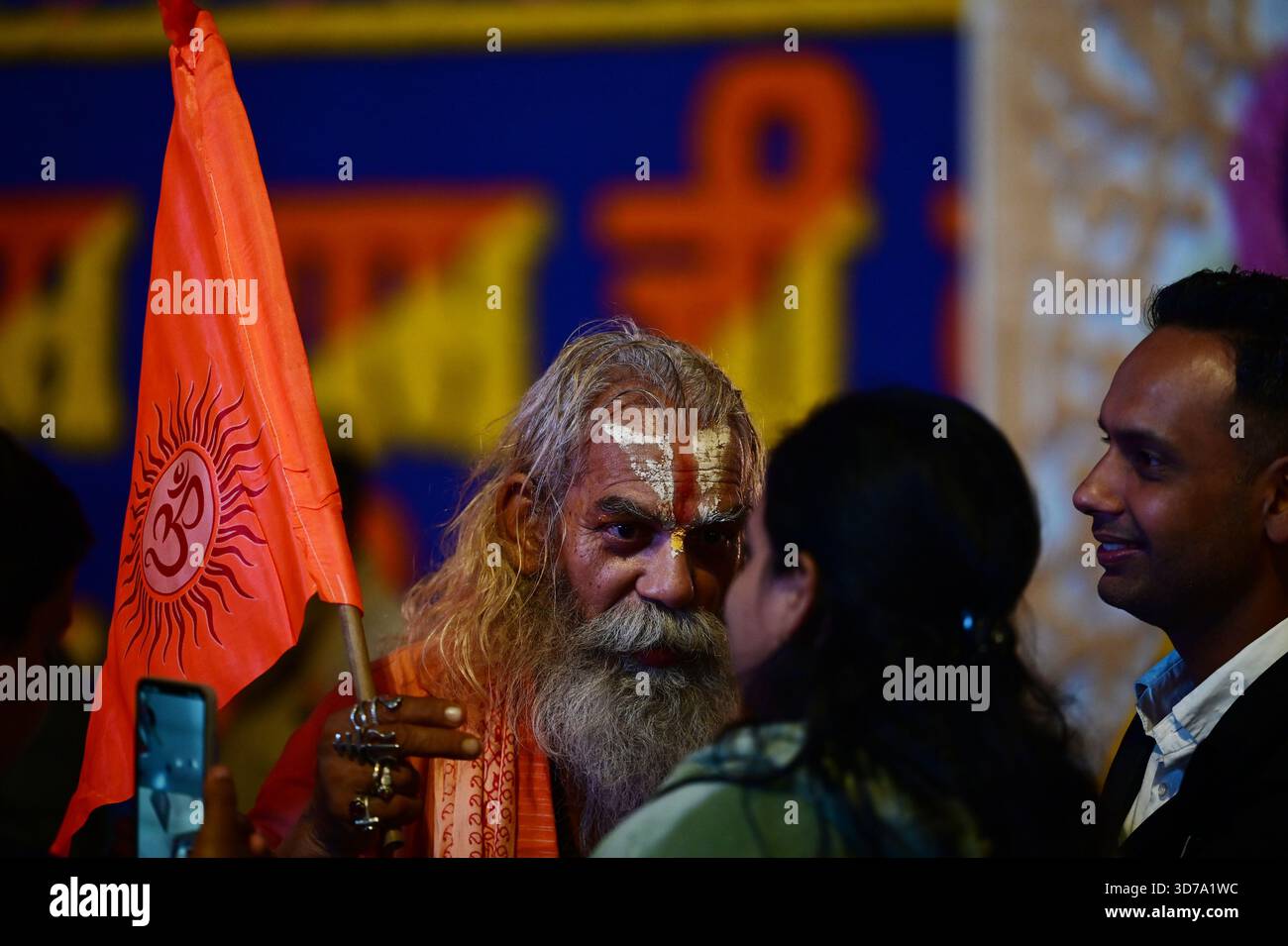 AYODHYA, INDIA - NOVEMBER 24: A Hindu seer holding saffron flag outside ...