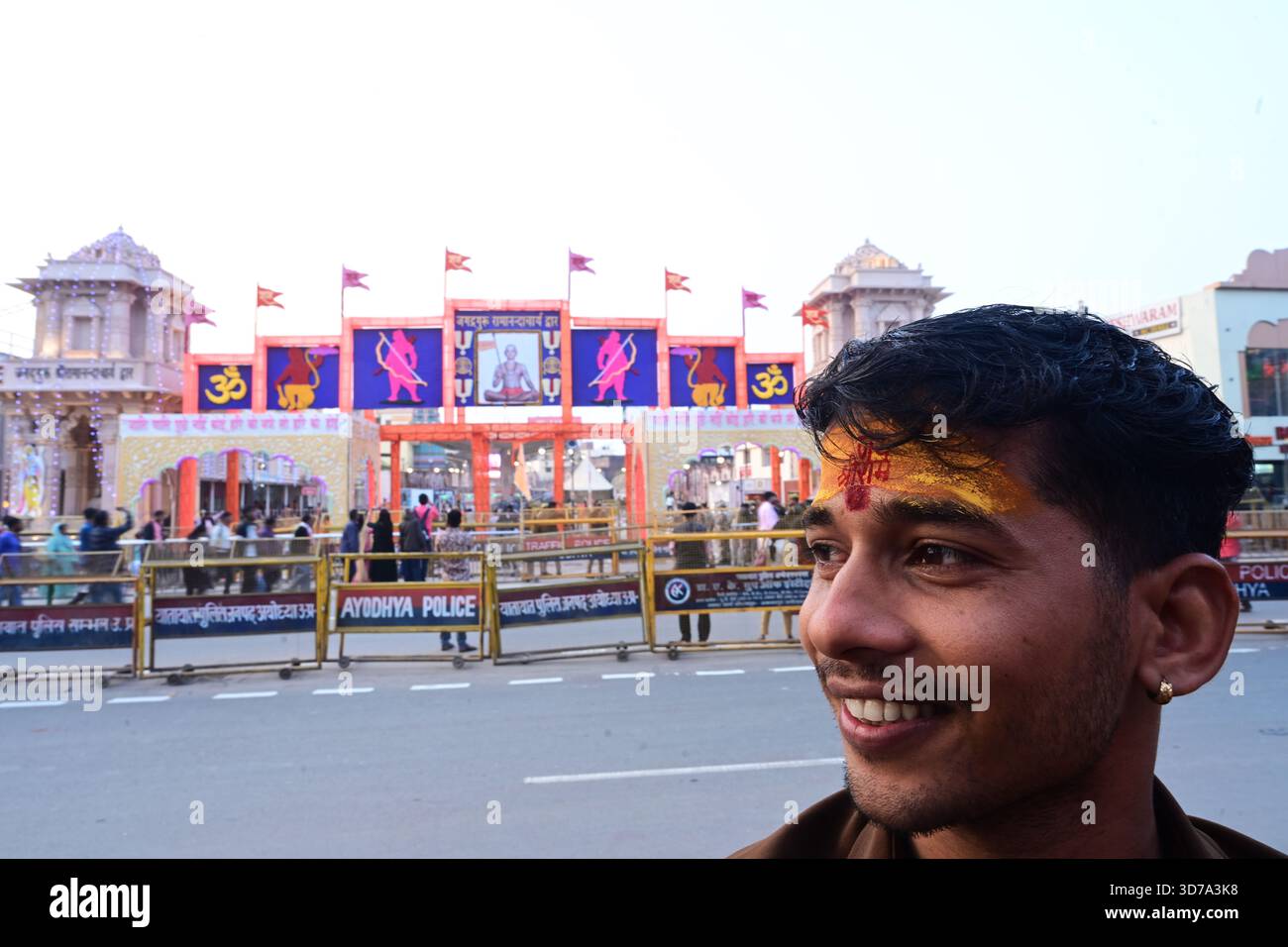 AYODHYA, INDIA - NOVEMBER 24: A young devotee outside the entrance gate ...