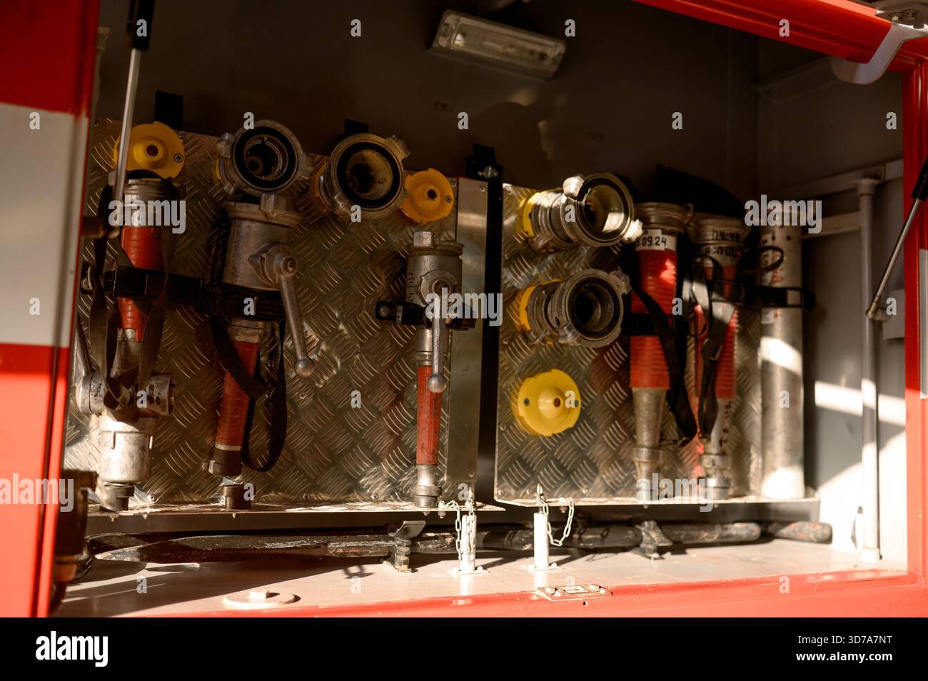Close-up of open fire engine compartment with hoses and coupling heads ...