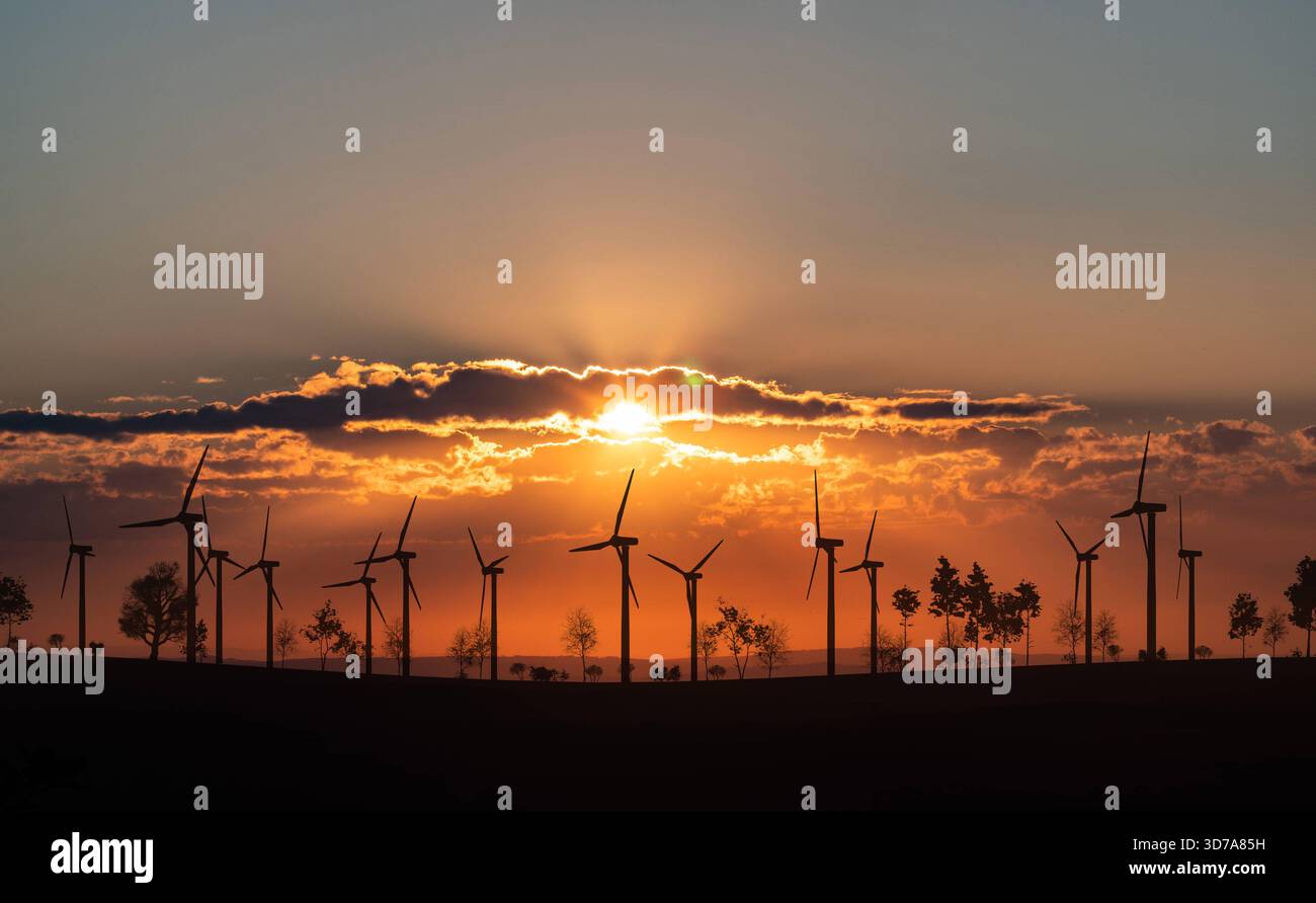 Wind turbines on the horizon during sunset, landscape with trees and ...