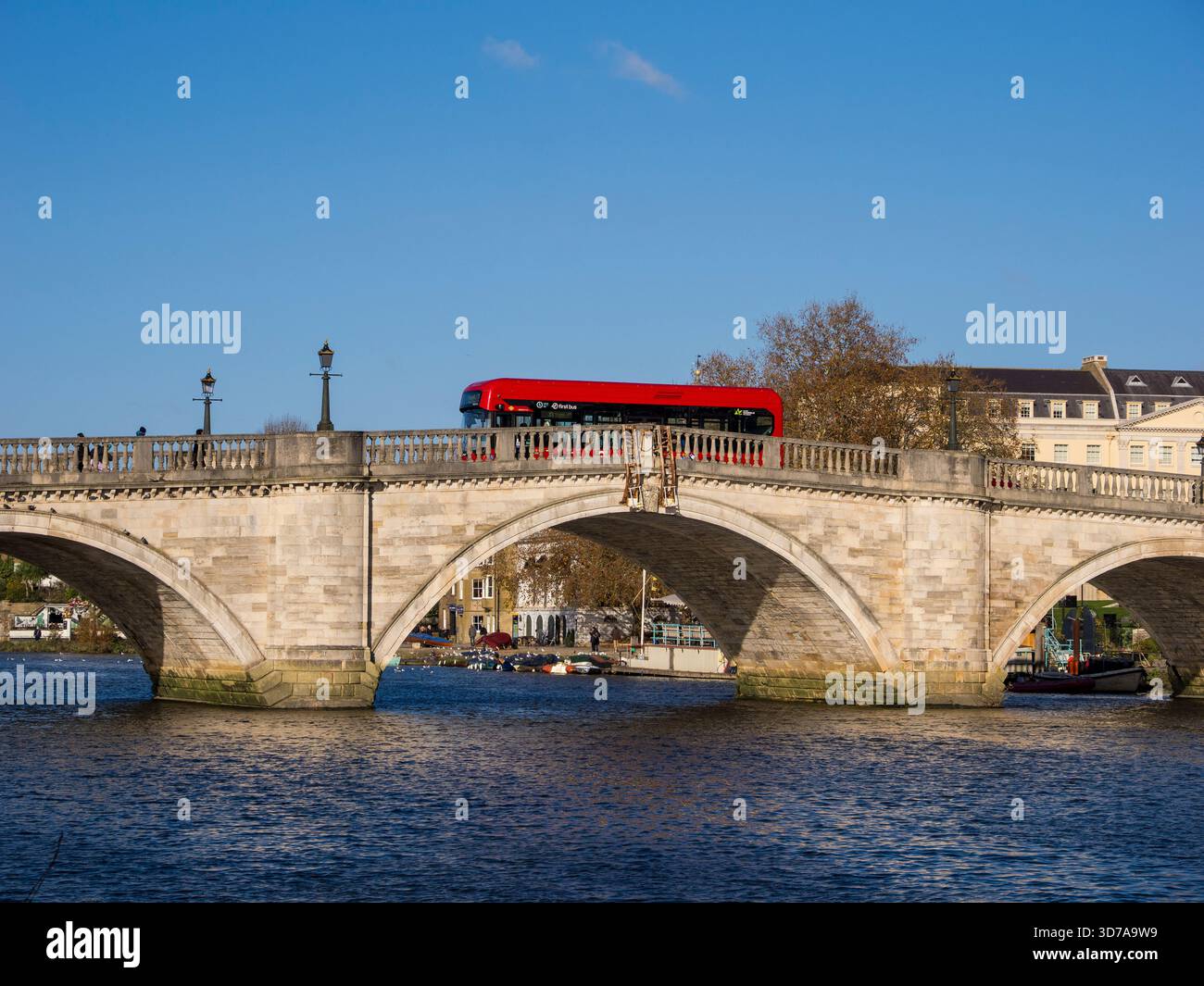Red London Bus crossing Richmond Bridge, River Thames, Richmond, London ...