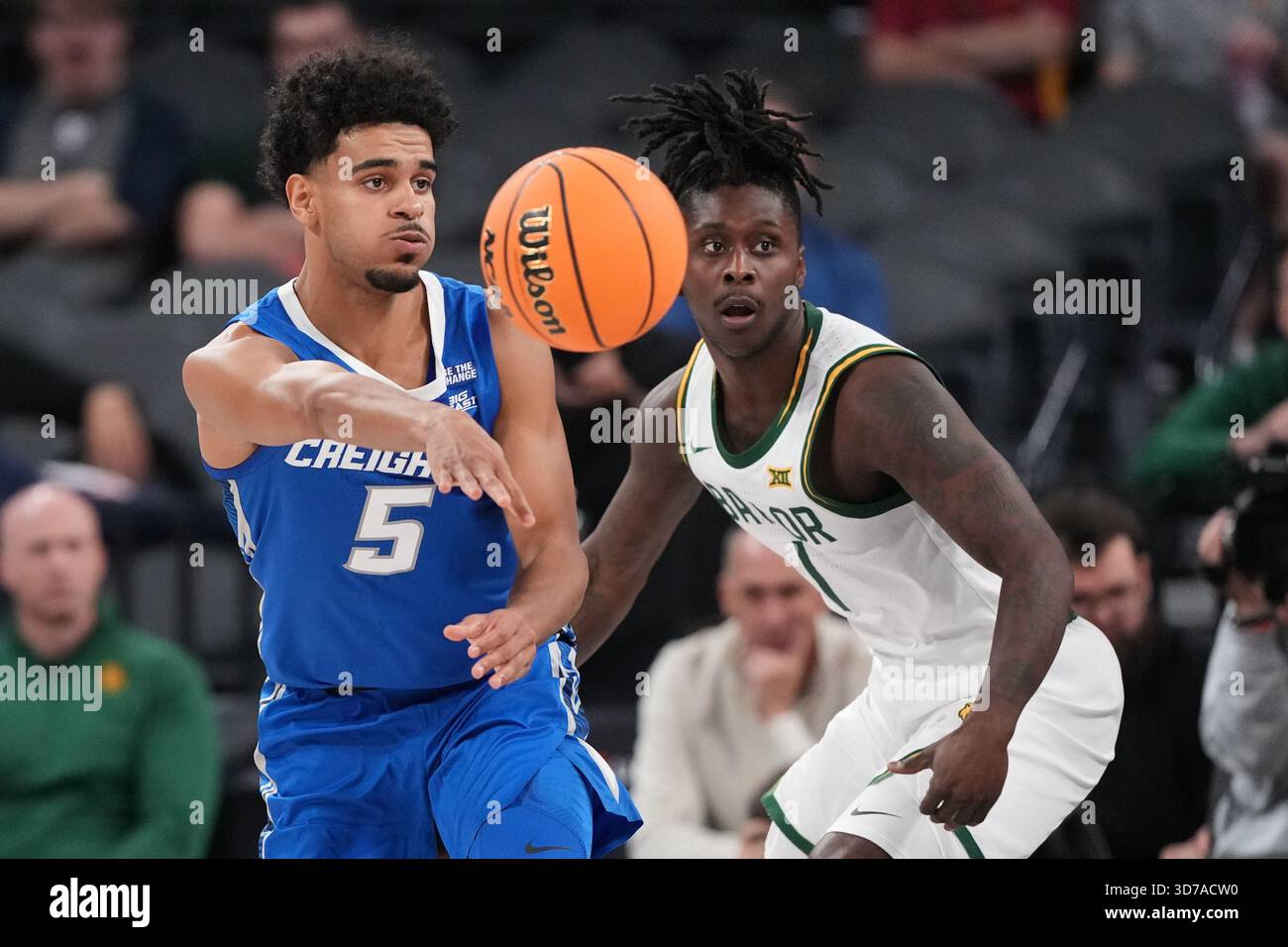 Creighton guard Nik Graves (5) passed the ball past Baylor guard JJ ...
