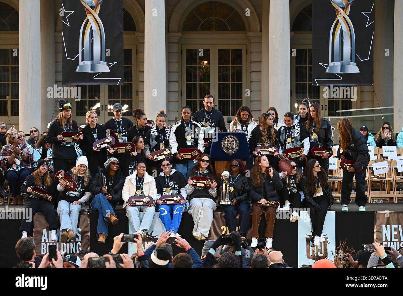 Member of the NY/NJ Gotham FC celebrates with the trophy during the ...