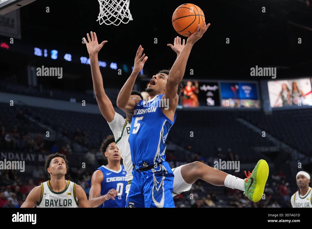 Creighton guard Nik Graves (5) drives to the basket against Baylor ...