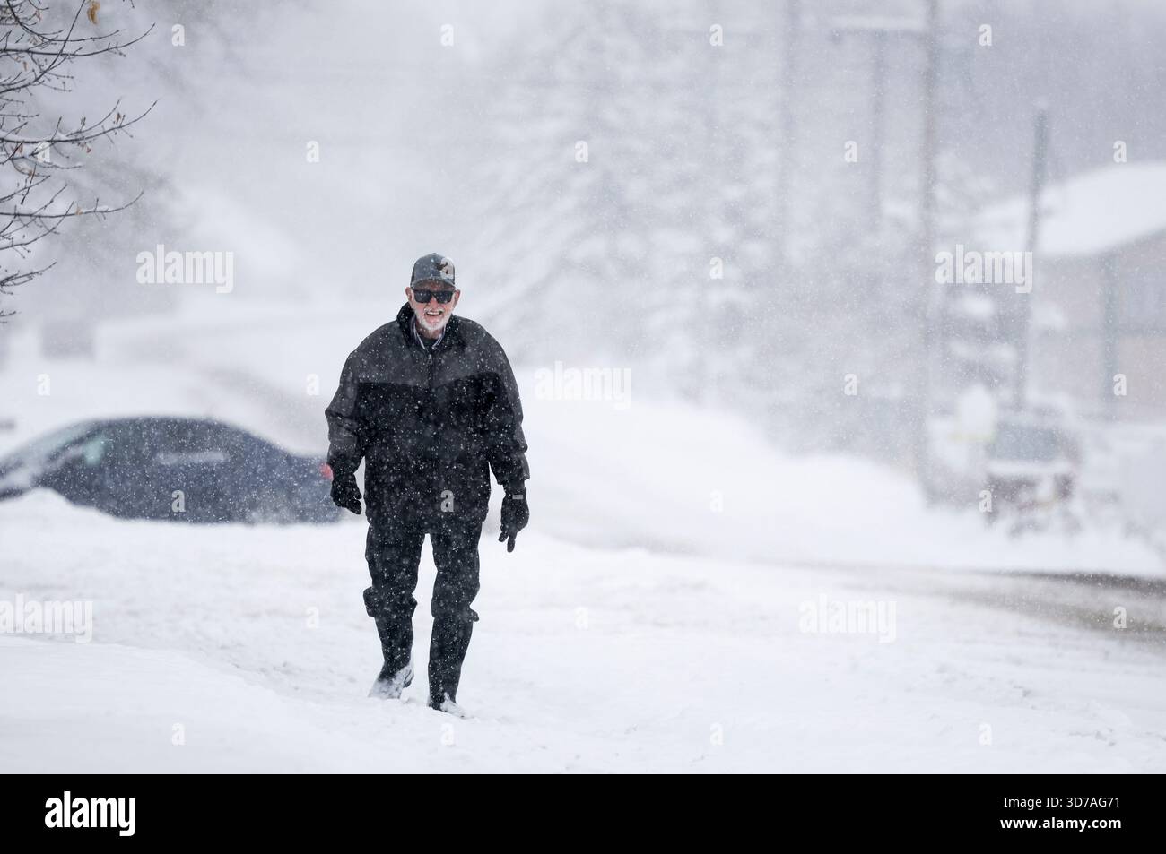 A resident of Cremona, Alta., trudges through snow on Monday, Nov. 24 ...
