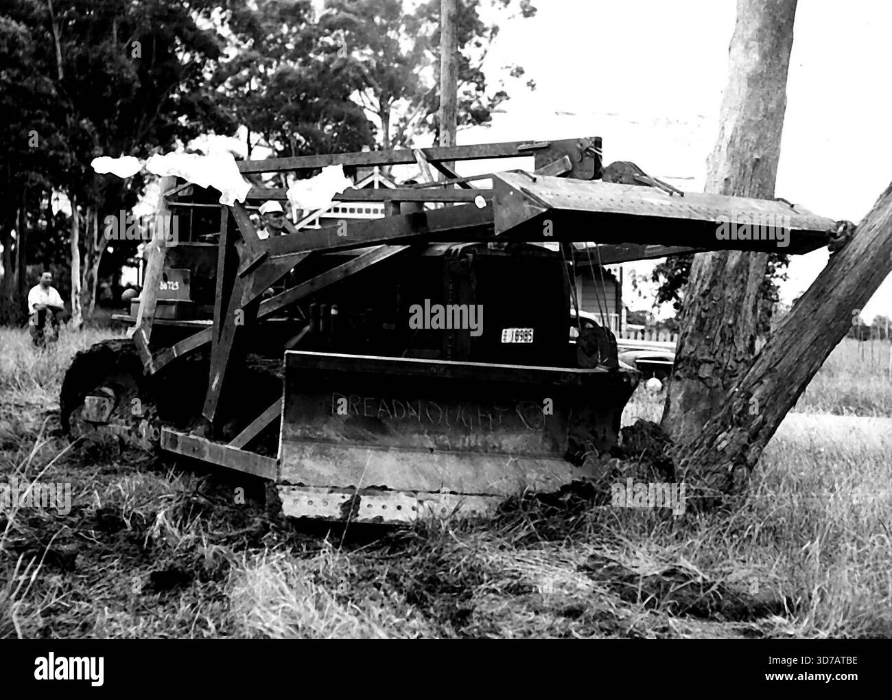 Treedozer blade pushes tree over with top blade; simultaneously the ...