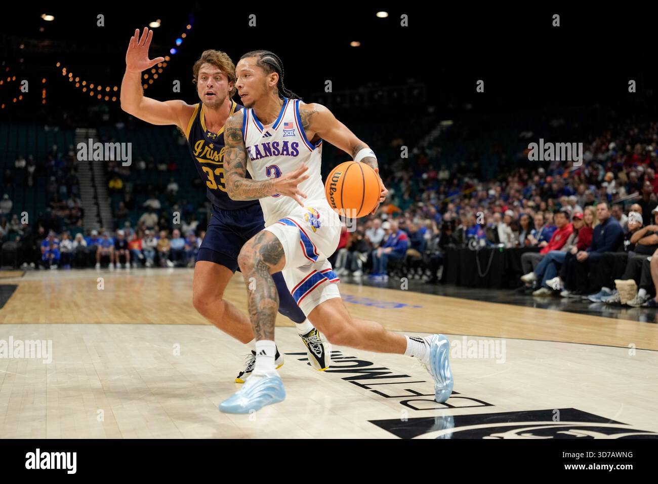 Kansas guard Tre White drives the ball against Notre Dame forward ...