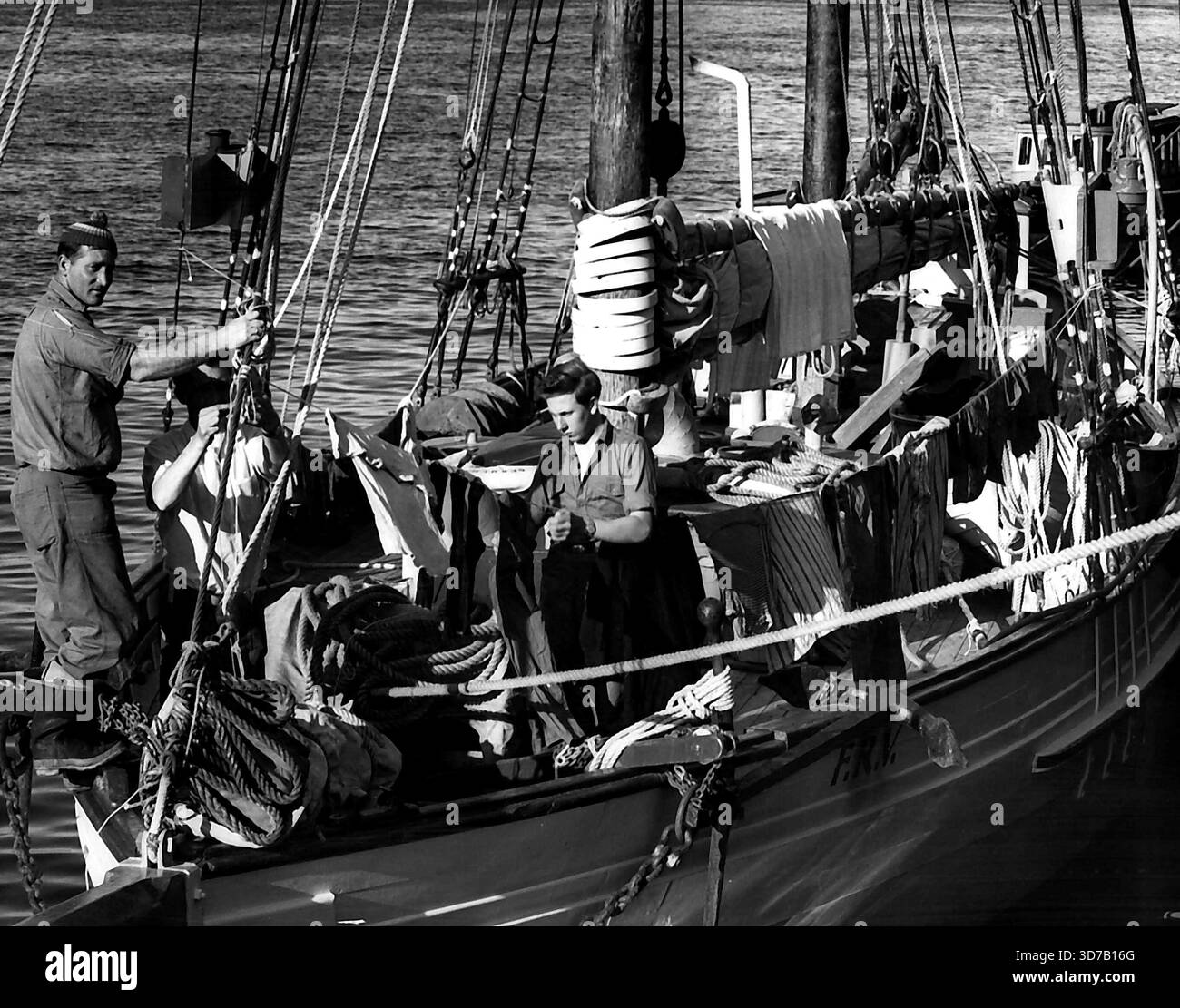 Crew members hanging out their washing. L to R. Ron Greig the mate, Reg ...