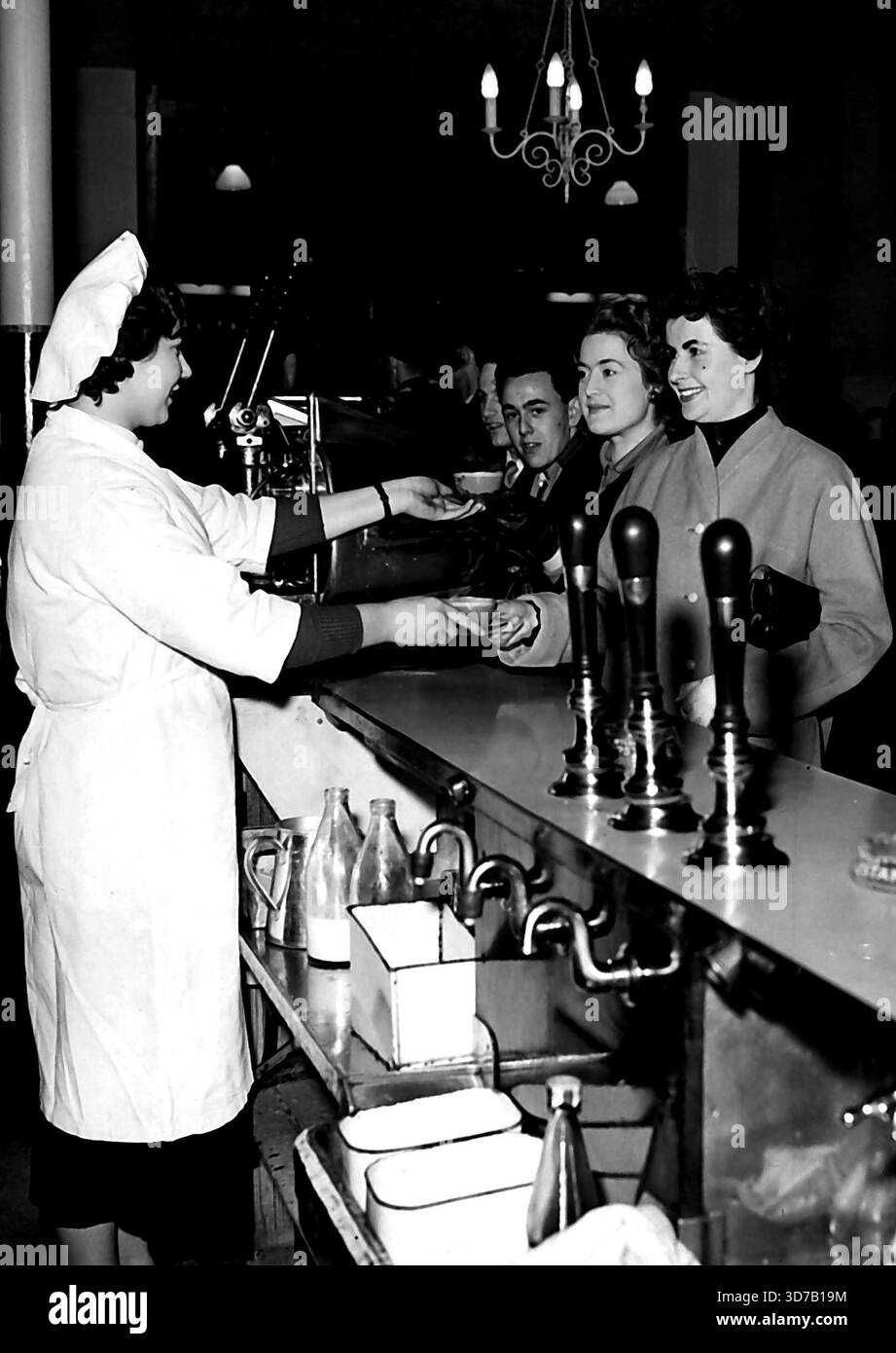 Coffee Bar -- Miss June Cook of Hendon seen serving coffee to two lunch ...