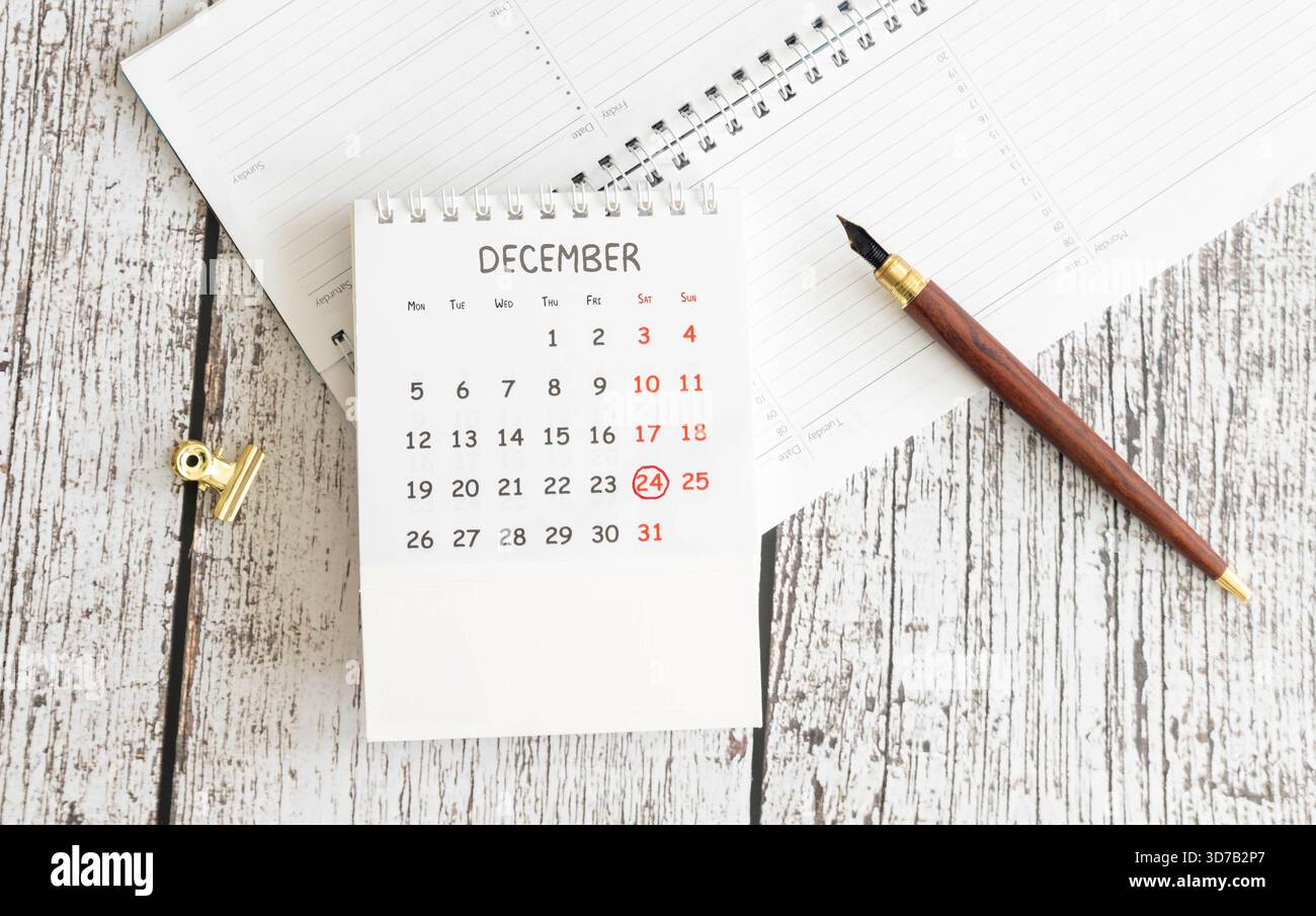 December 24, Calendar design with Christmas tree on red table ...