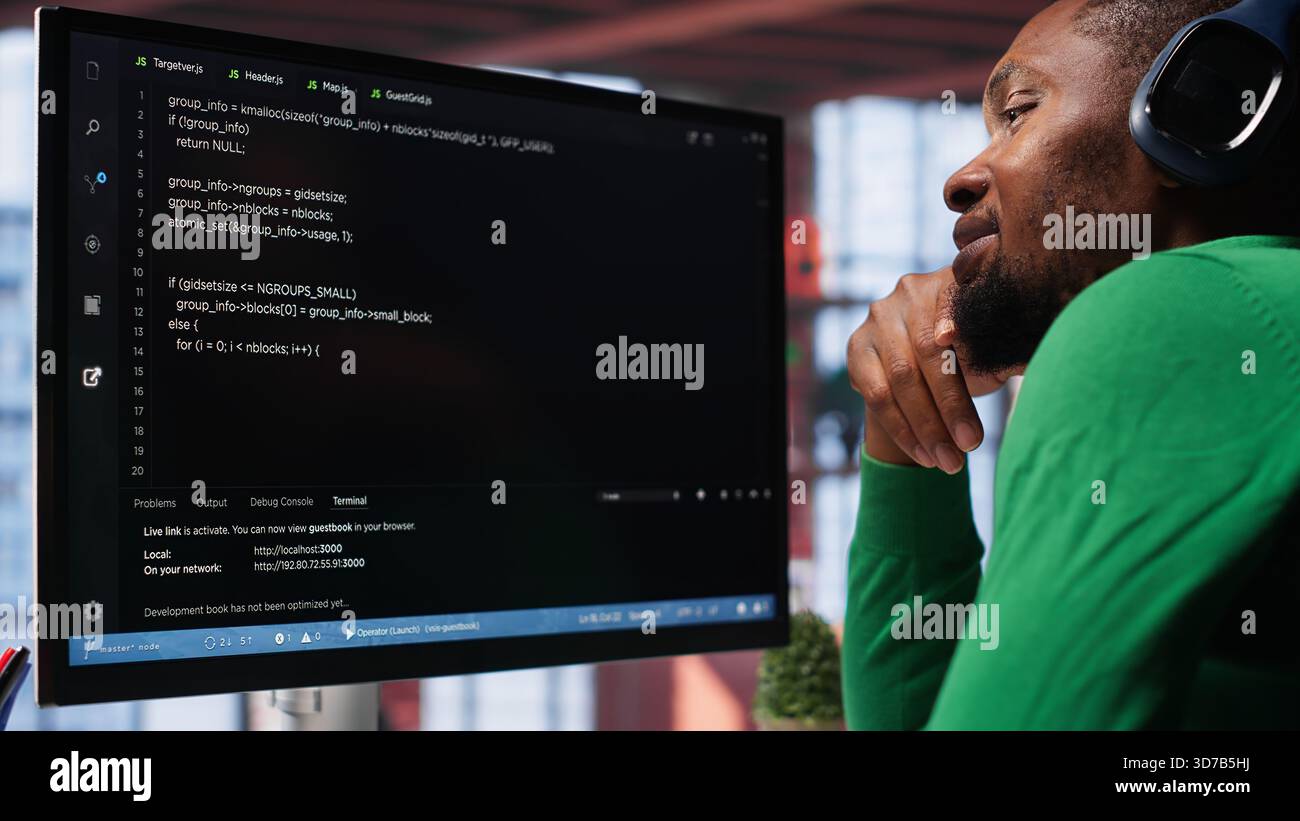 Young IT engineer typing code on computer and running script ...