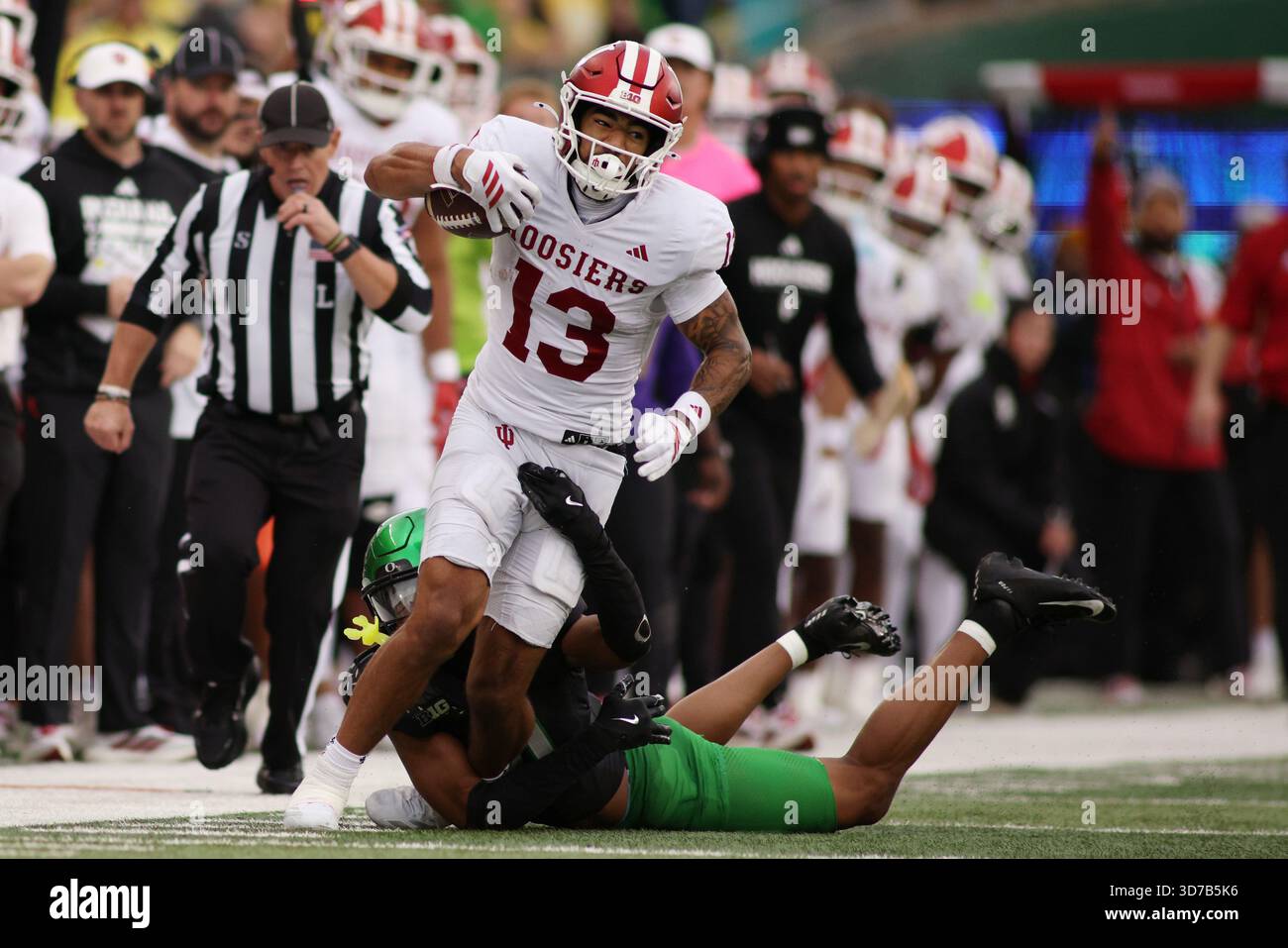 FILE - Indiana wide receiver Elijah Sarratt (13) attempts to break a ...