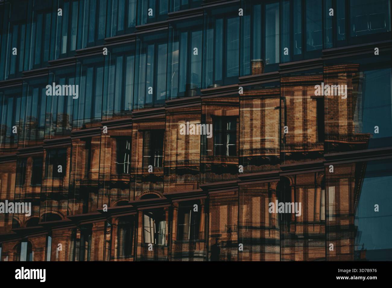 Architectural reflection in modern glass building. A striking ...
