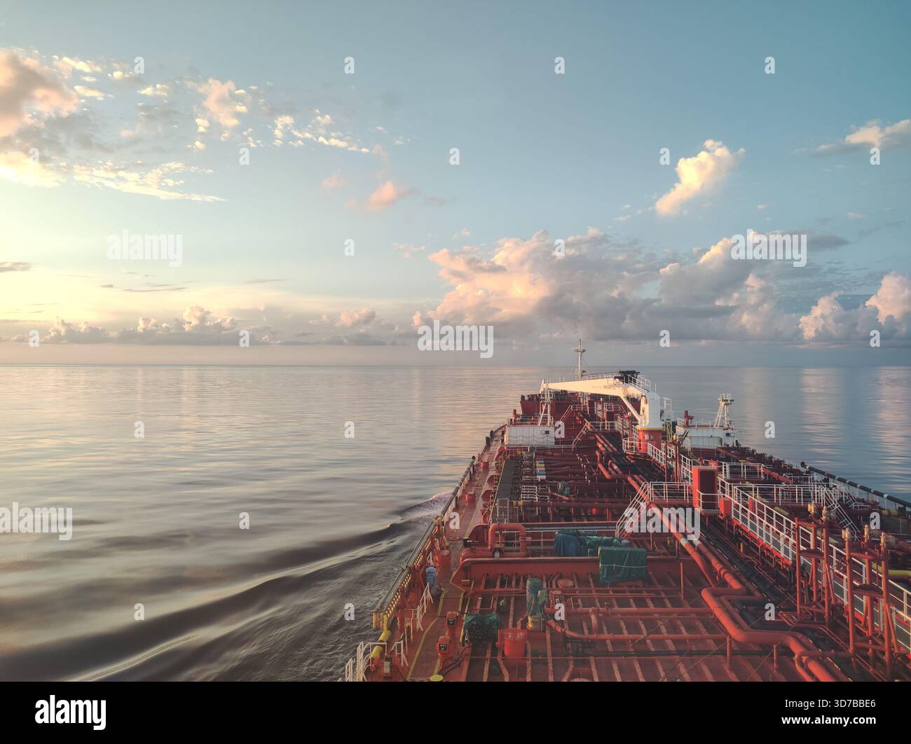 Cargo ship sailing sunset hi-res stock photography and images - Alamy