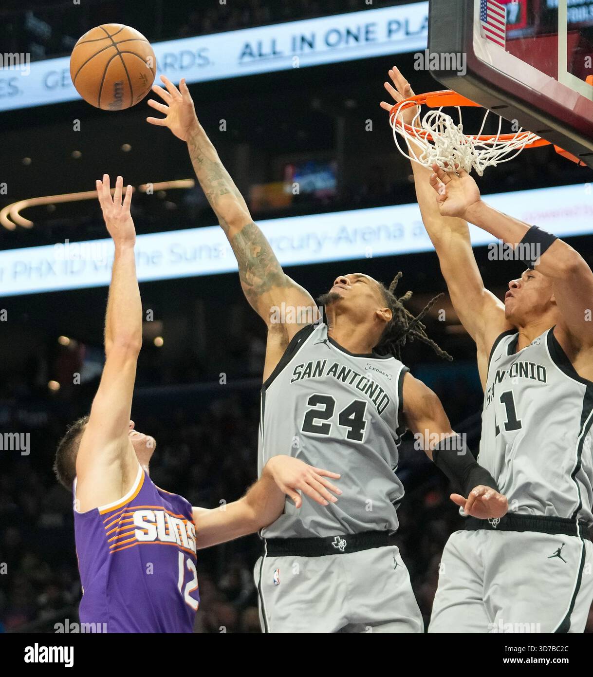 San Antonio Spurs guard Devin Vassell (24) blocks Phoenix Suns guard ...