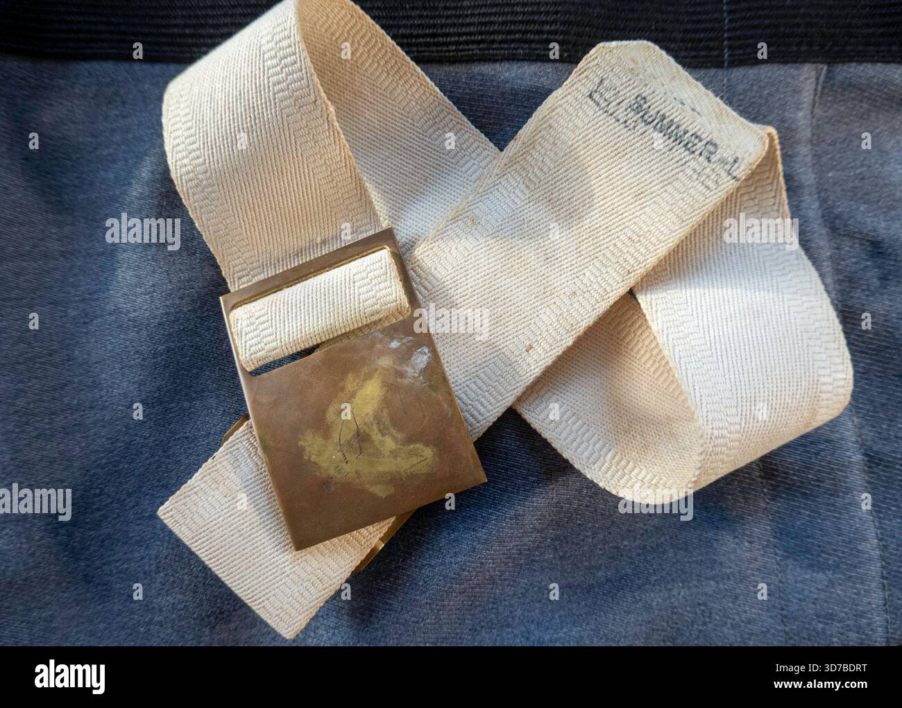 Still life of vintage West Point cadet white belt and tarnished belt ...