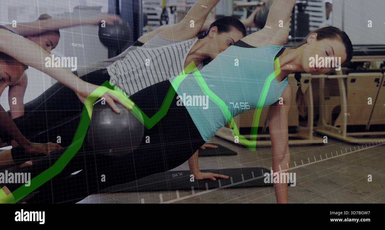 Balancing women doing side-plank on mats in gym, in leggings, holding ...