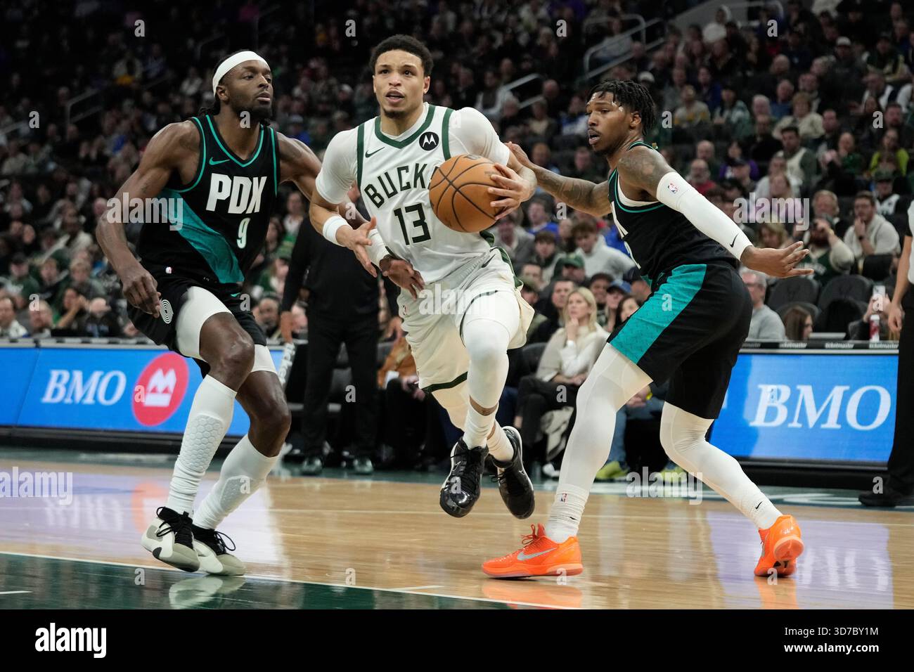 Milwaukee Bucks' Ryan Rollins (13) drives to the basket between ...