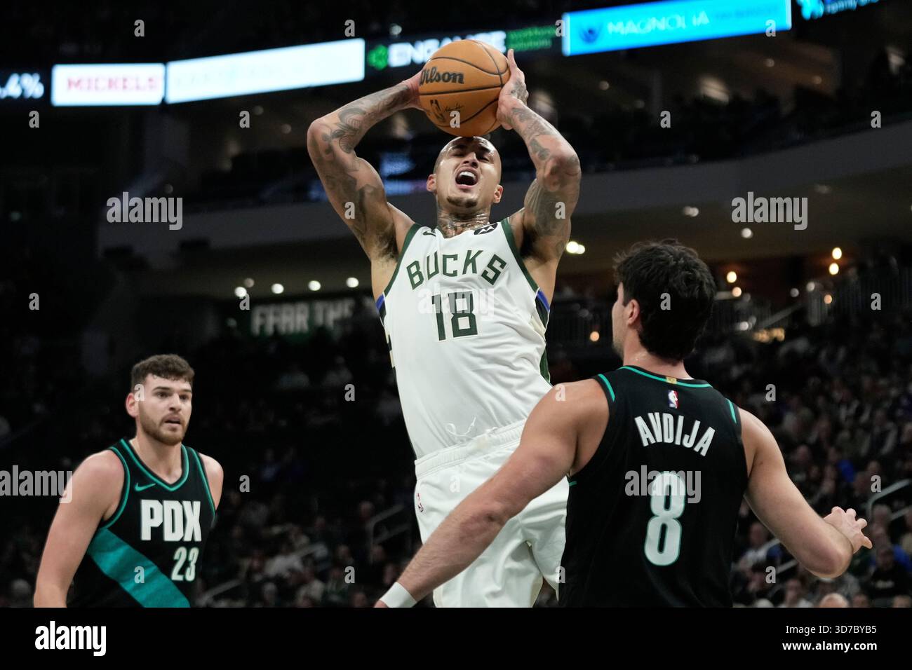 Milwaukee Bucks' Kyle Kuzma (18) drives to the basket between Portland ...