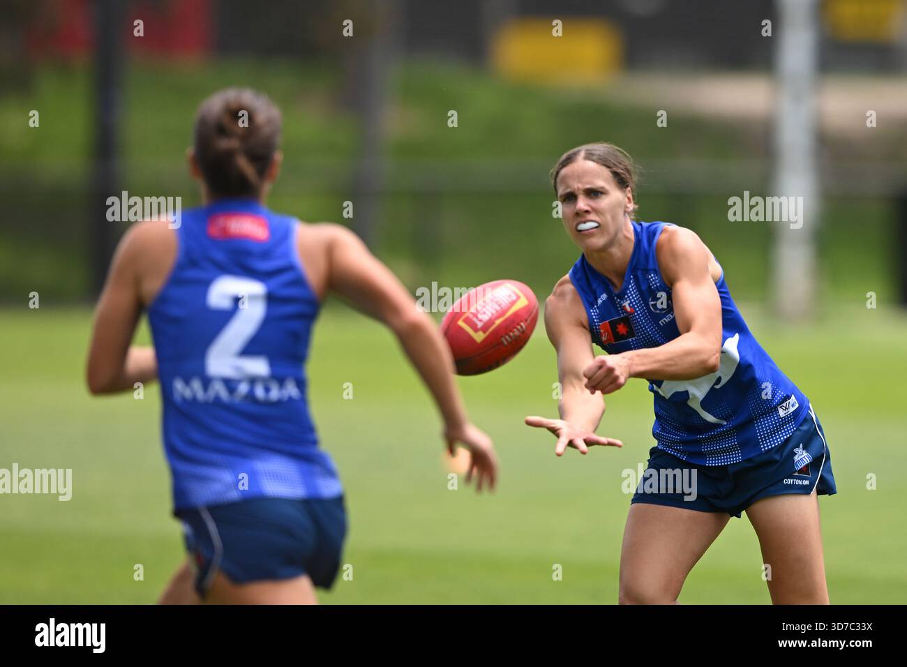 Jasmine Garner of the Kangaroos (right) hand balls the footy during a ...
