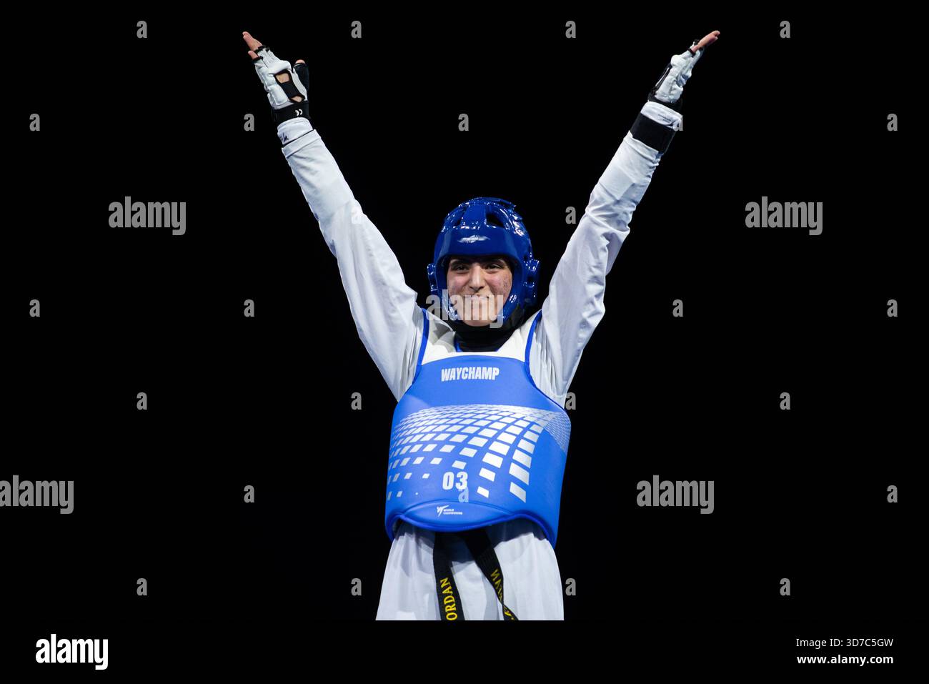 Fadia Khirfan from Jordan (Blue) celebrates after winning over Faith ...