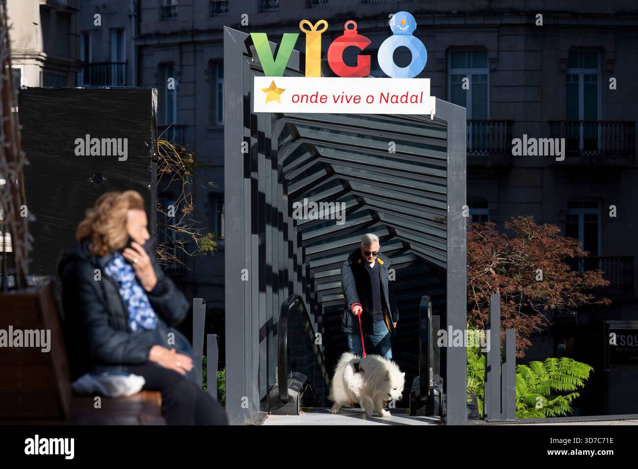 November 17, 2025, Vigo, Spain: A man walks his dog past a Christmas ...