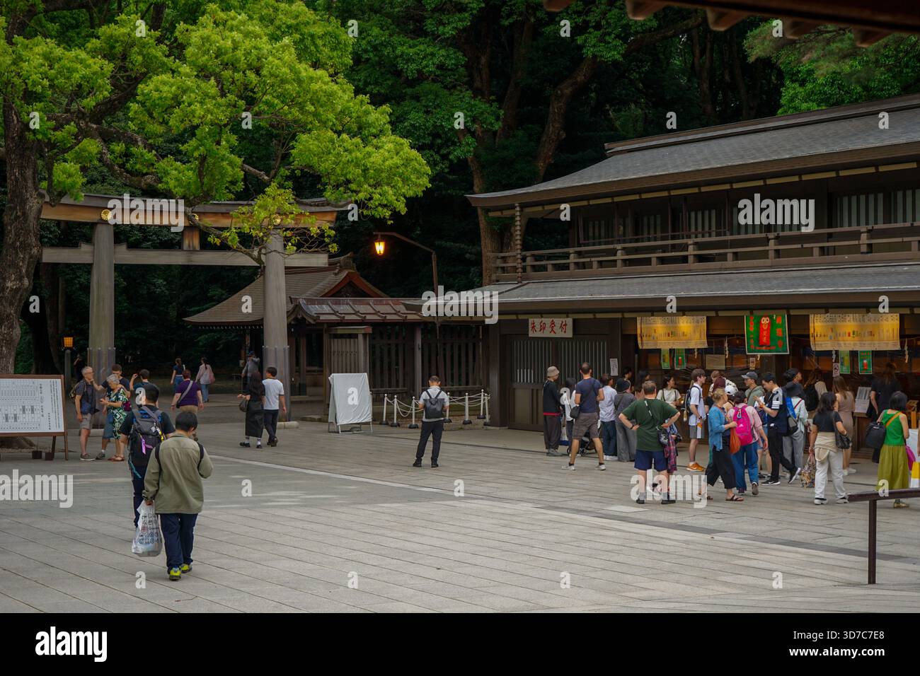 Large Torii gate entrance to the Meiji Jingu Shrine and a building ...
