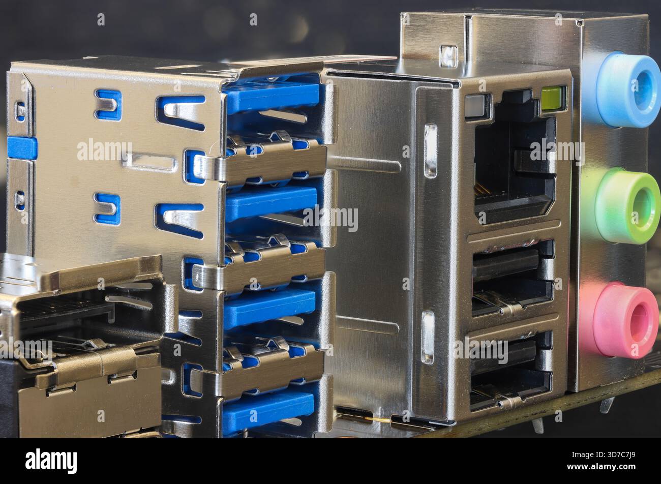 Close-up of a metal back panel featuring stacked USB ports, RJ 45 and ...