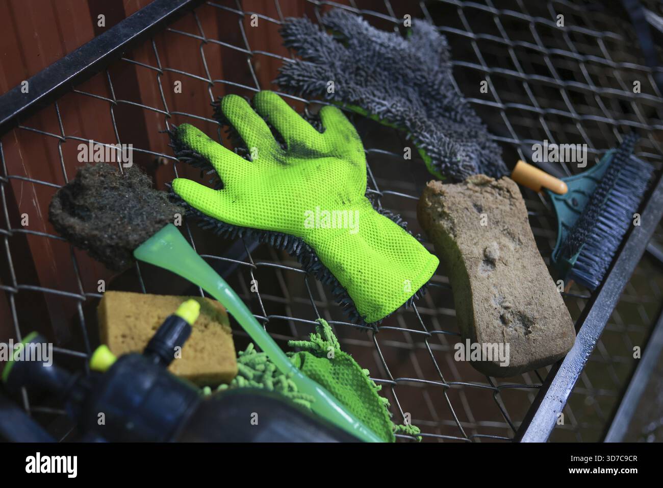 Dirty cleaning equipment after messy work. green rubber glove, sponge ...