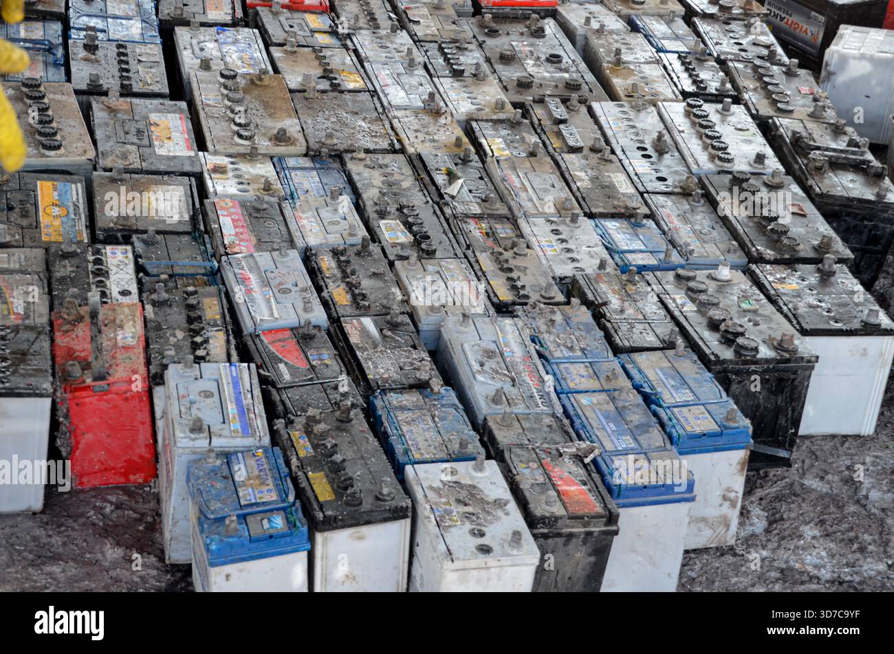 High-angle, full-frame shot of numerous used car batteries collected ...