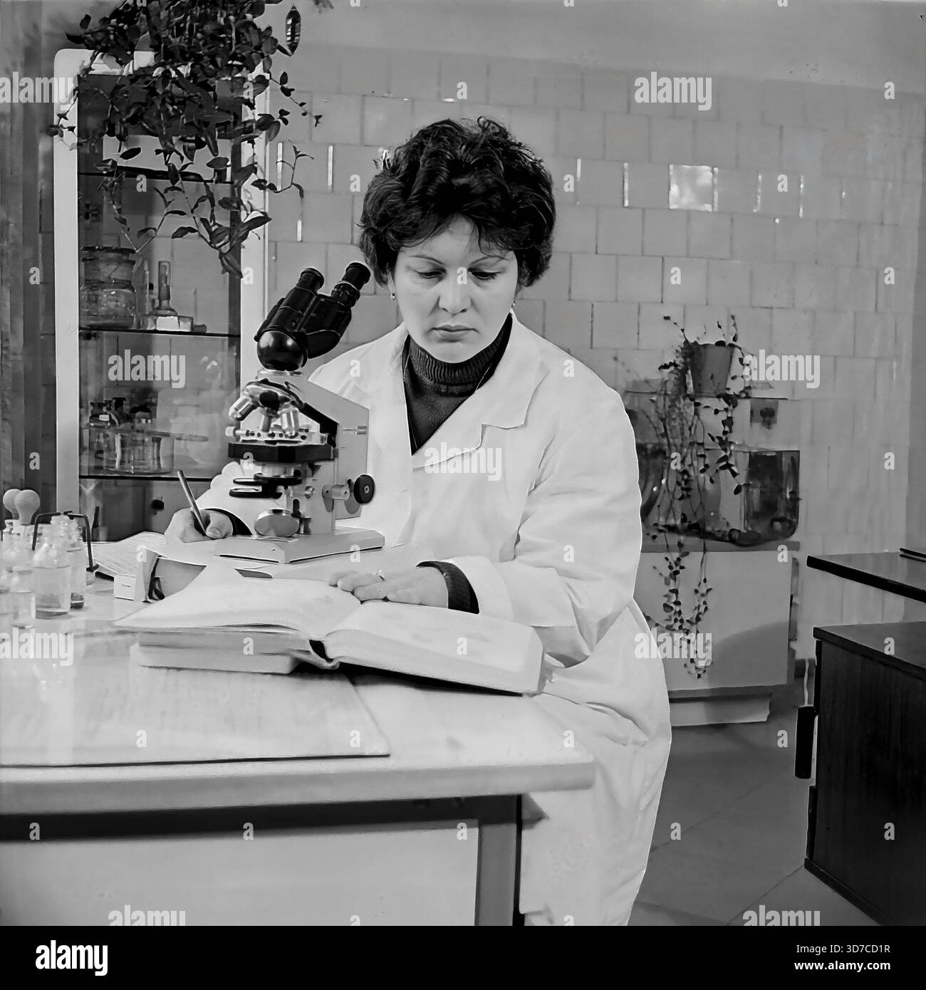 Woman laboratory technician sits table hi-res stock photography and ...