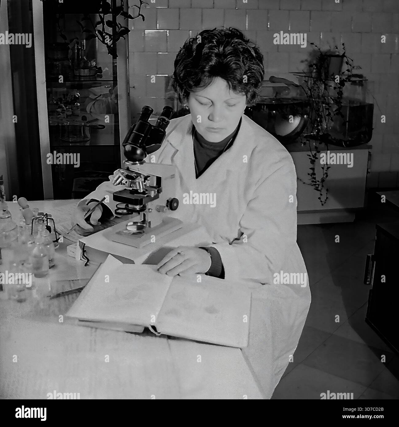 Woman laboratory technician sits table hi-res stock photography and ...
