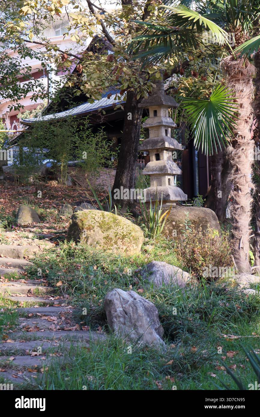 Serene Japanese garden scene featuring ancient stone lantern, moss ...