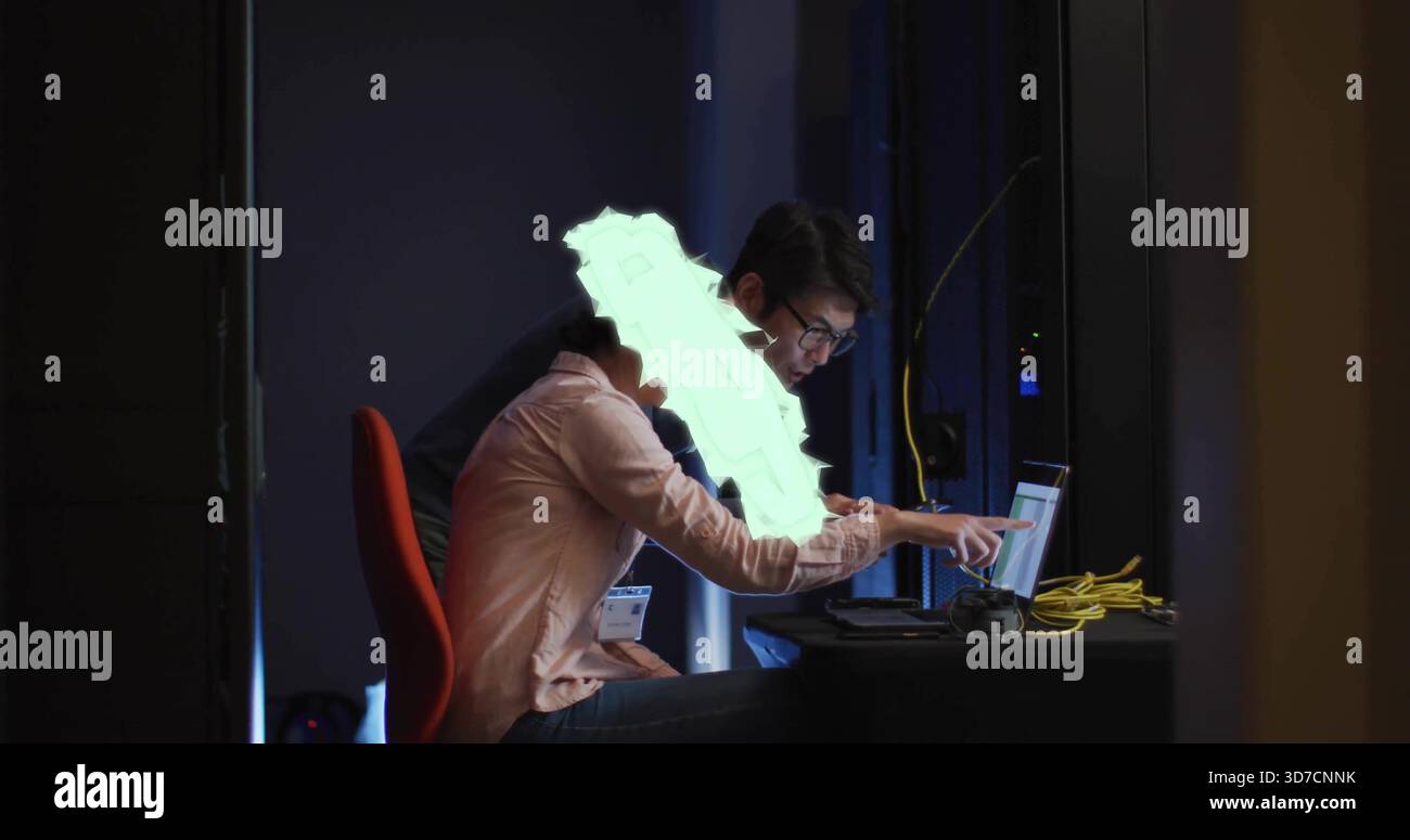 Collaborating AV team light pink shirt and dark jacket checking laptop ...