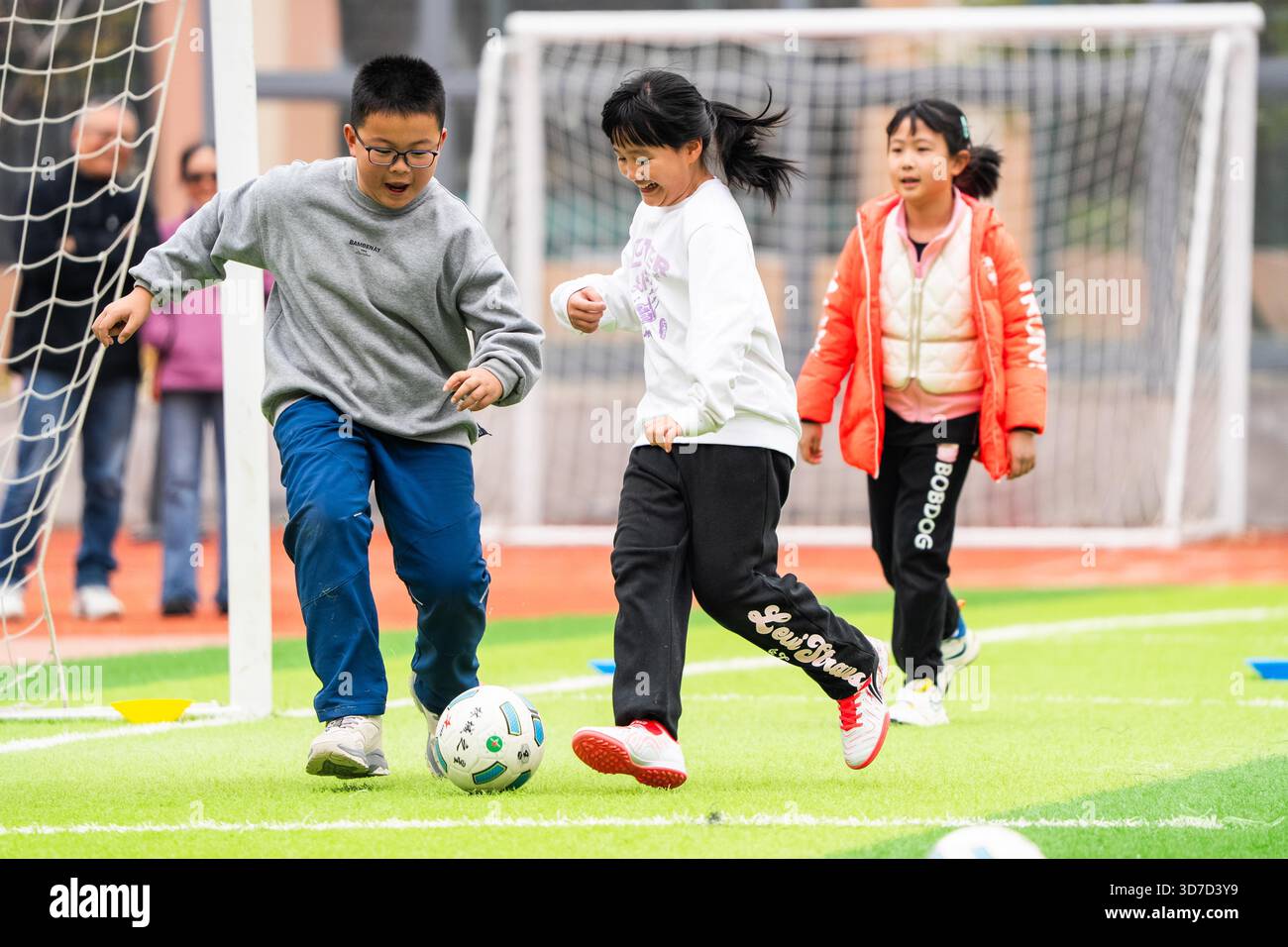 Children learn to play football at a shool in Bijie City, southwest ...