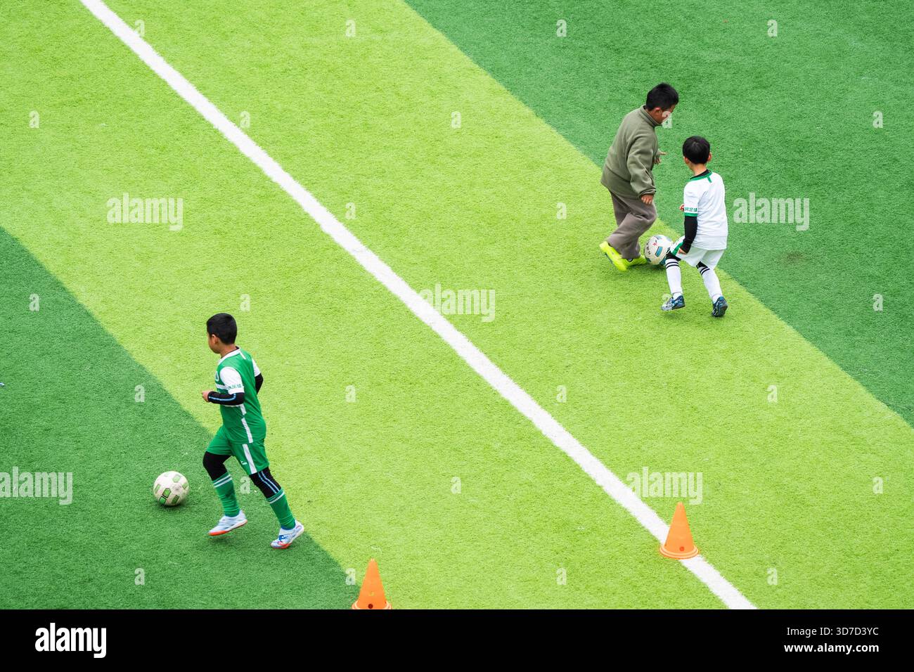 Children learn to play football at a shool in Bijie City, southwest ...