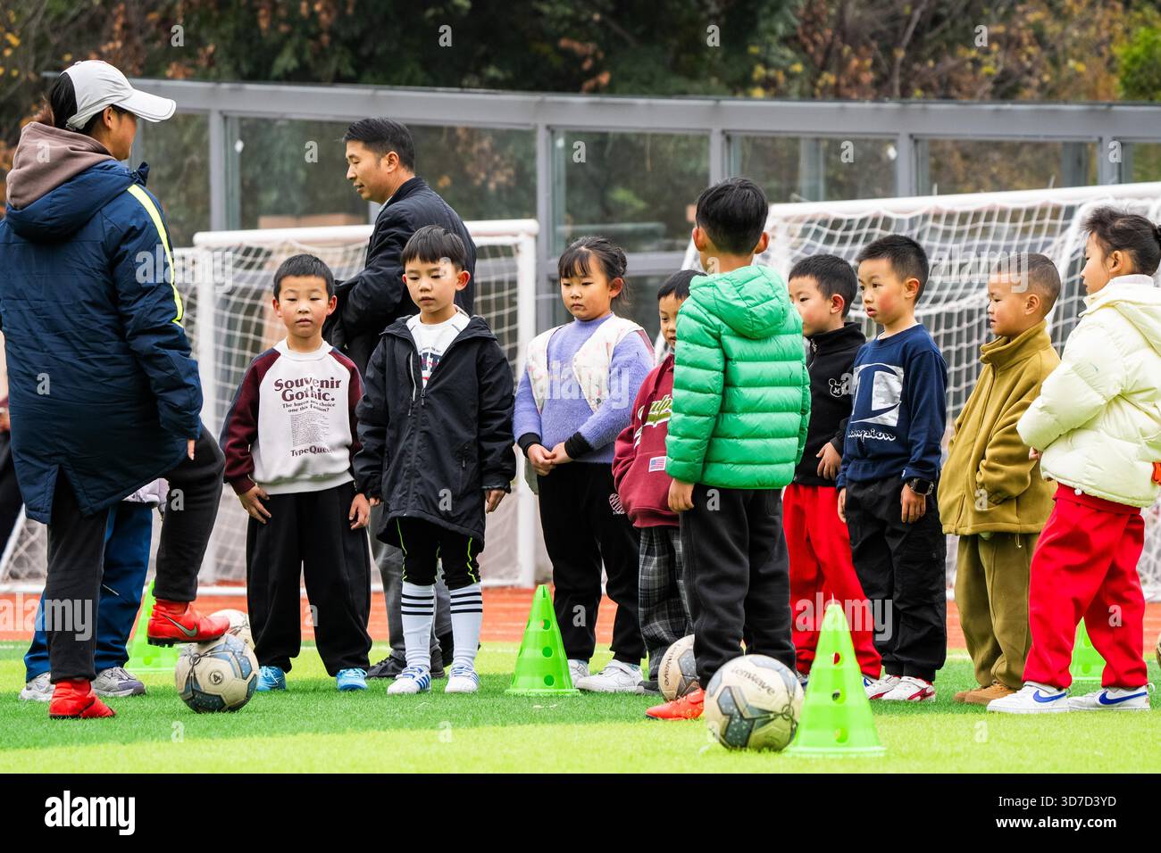 Children learn to play football at a shool in Bijie City, southwest ...
