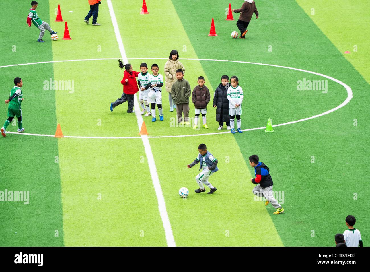 Children learn to play football at a shool in Bijie City, southwest ...