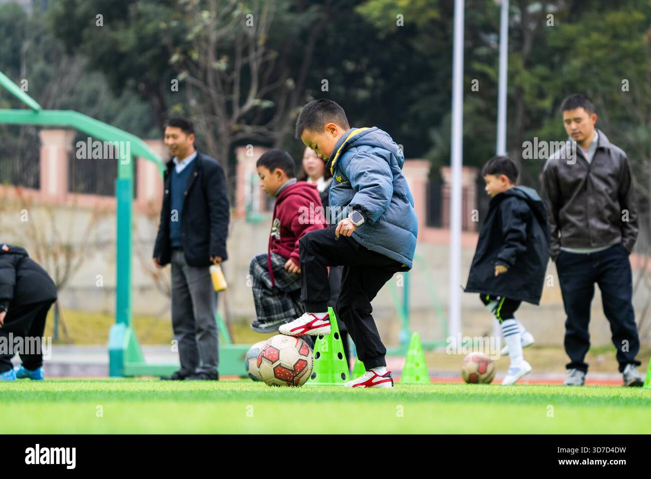 Children learn to play football at a shool in Bijie City, southwest ...