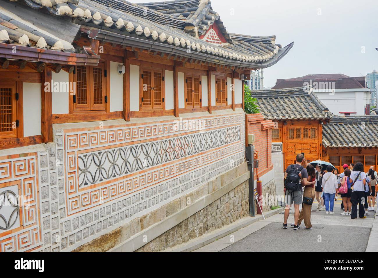 At historic Bukchon Hanok Village with hanok style homes, a crowd of ...