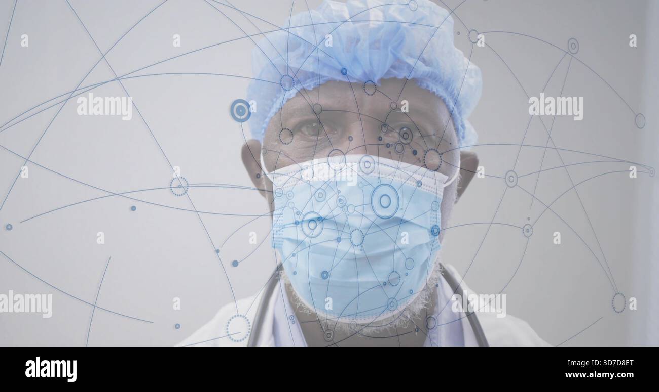 Facing camera doctor posing in clinic room, wearing mask, lab coat ...
