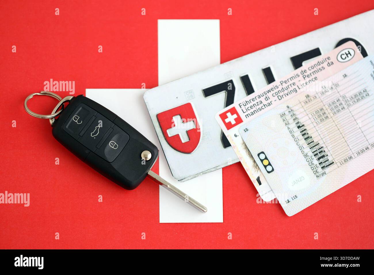 Switzerland car license plate and ignition key on Swiss flag close up ...