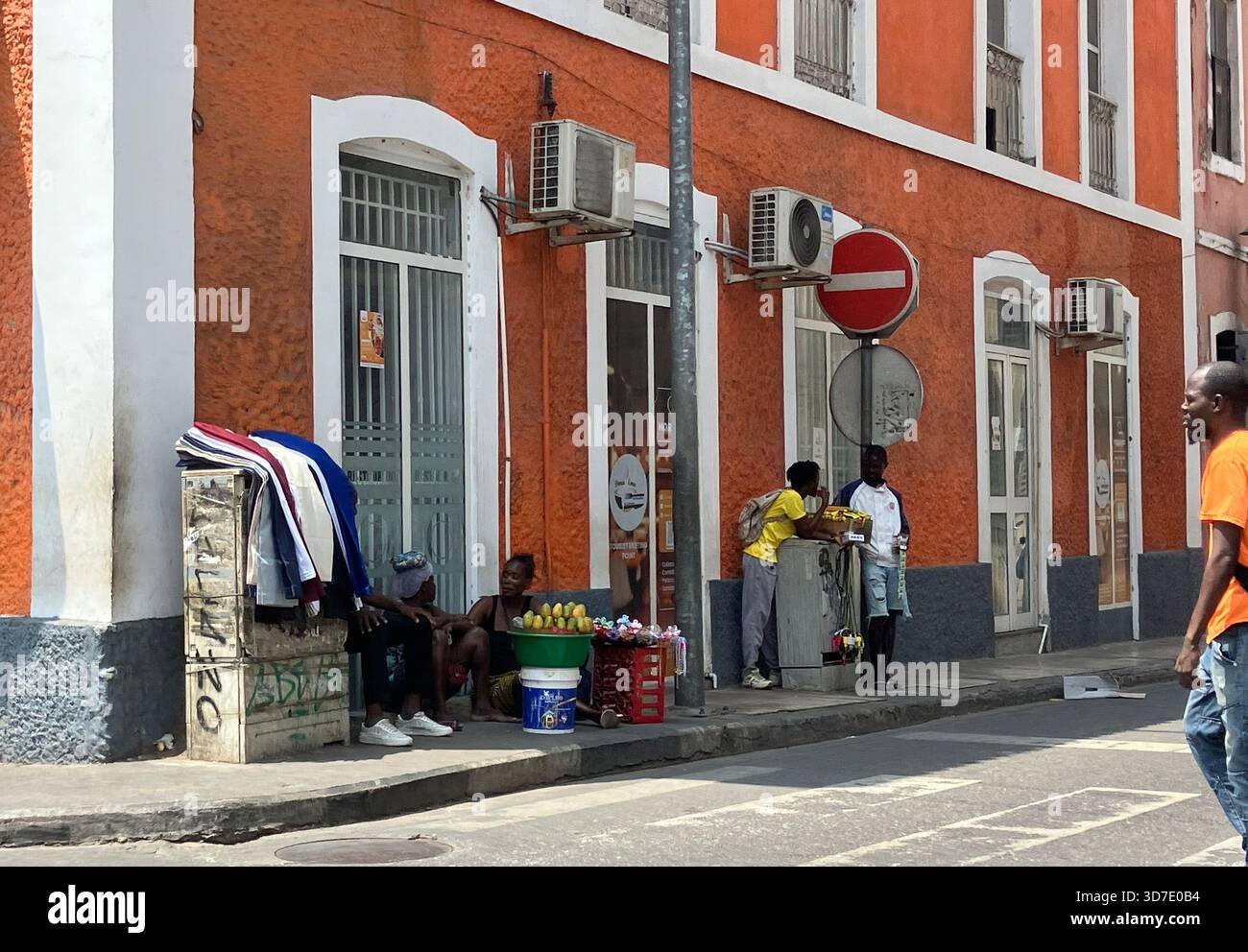 24 November 2025, Angola, Luanda: People standing in front of a store. Photo: Eva Krafczyk/dpa ...