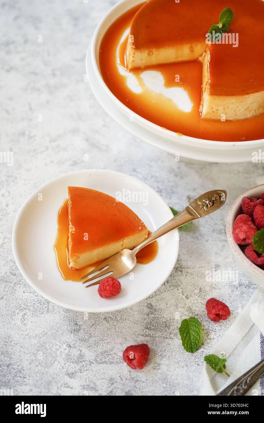 Homemade Flan | Creme caramel pudding served with raspberries Stock ...