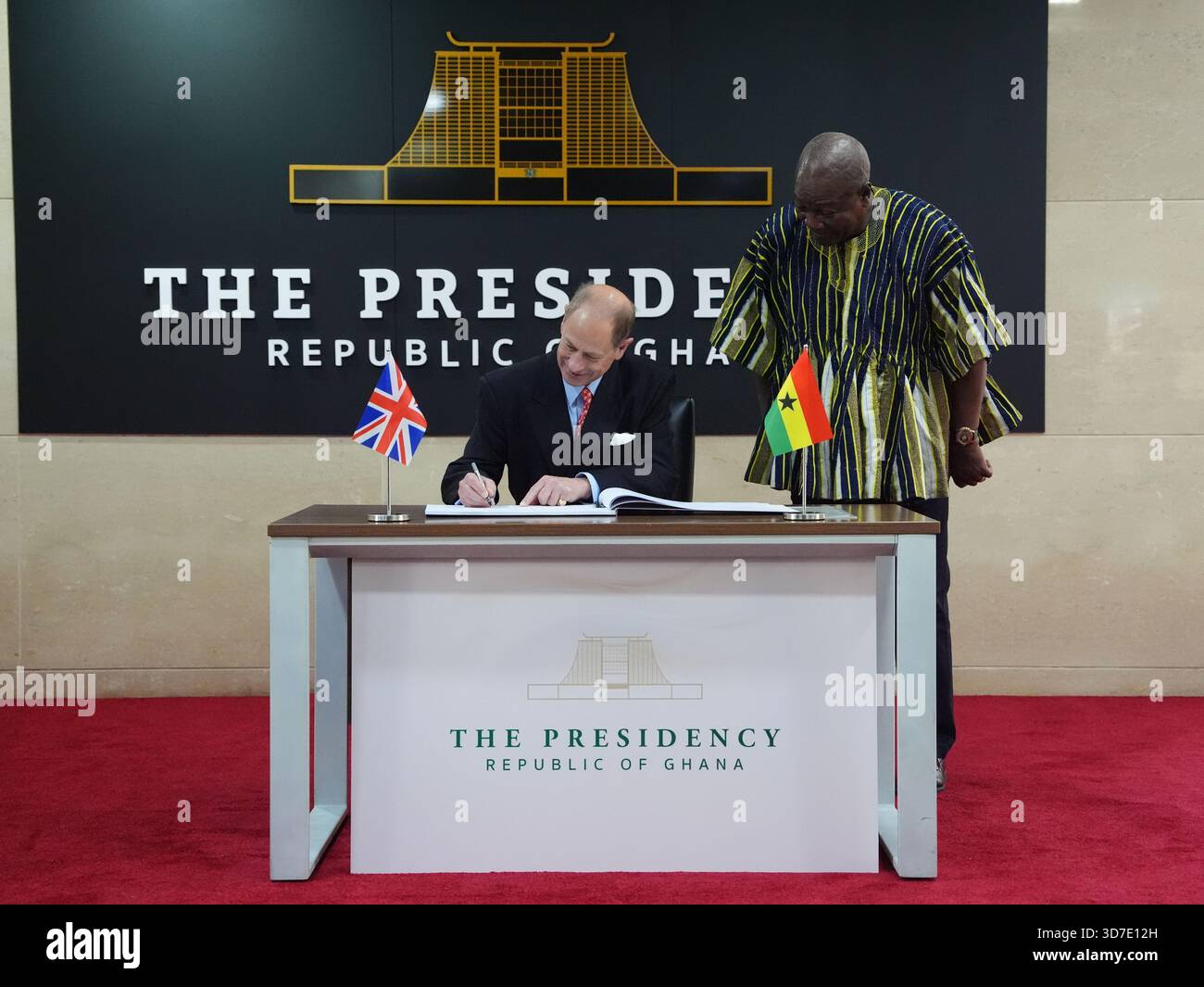 The Duke of Edinburgh (left) signs the guest book, with the President ...