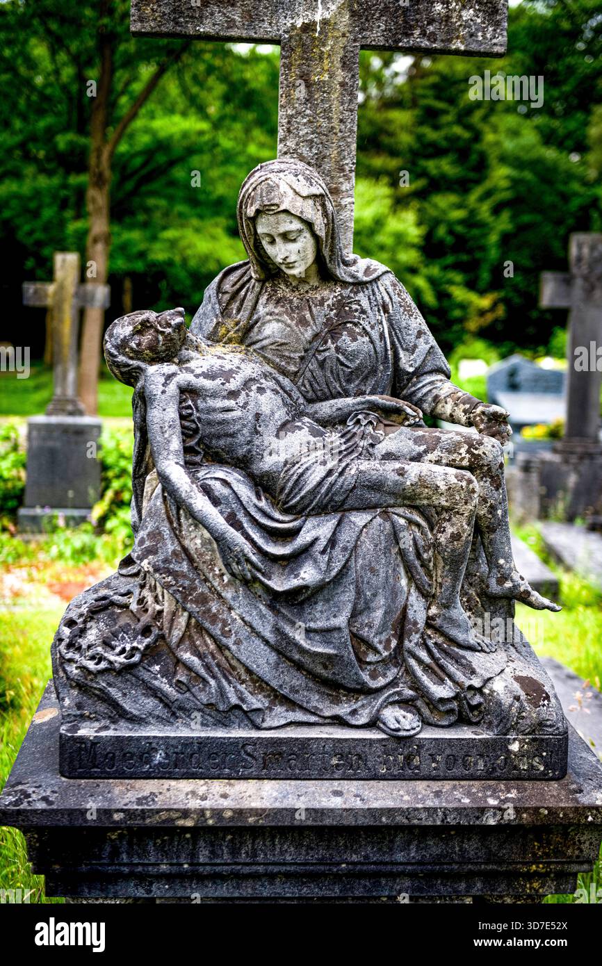 Weathered Pietà Sculpture on Grave Monument in Historic Cemetery Stock ...