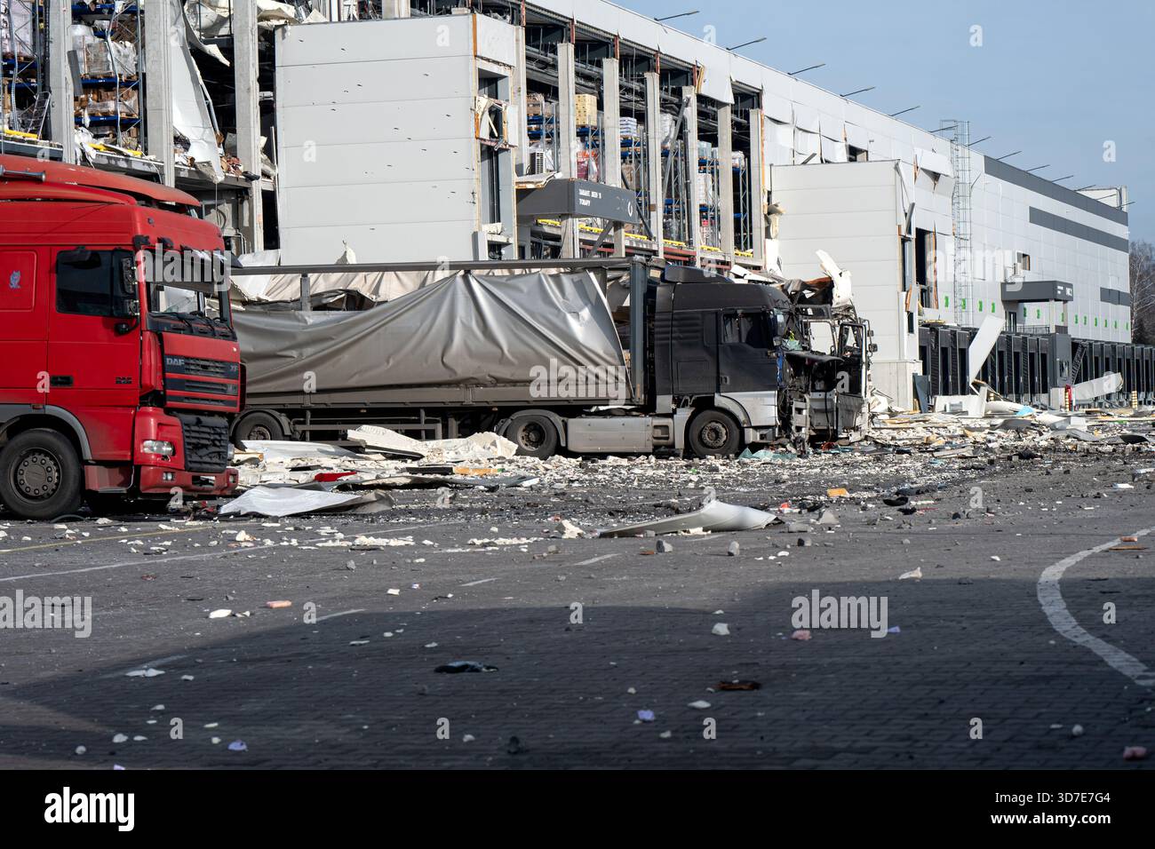Damaged trucks are seen on the grounds of a logistics center of a ...